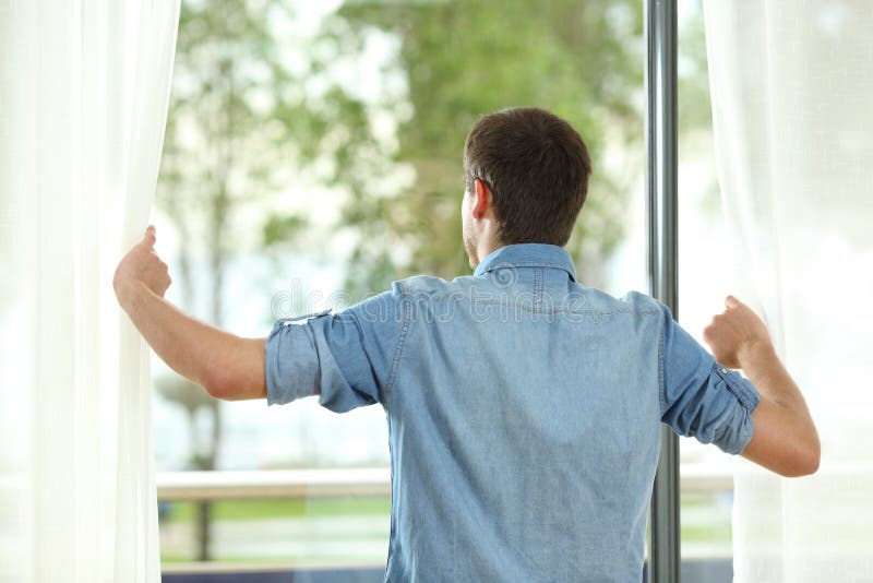 Back View of Man Opening Curtains and Looking Away Stock Photo - Image ...