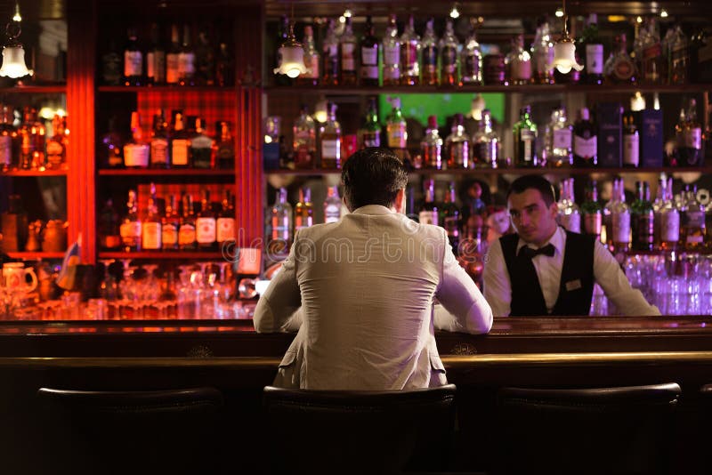 Back View of a Man Ordering Drink To a Bartender Stock Image - Image of ...