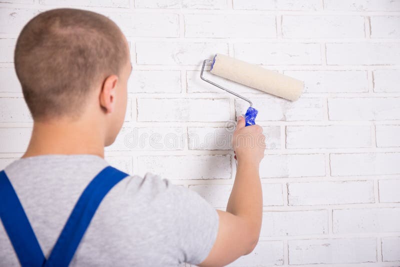 Back View of Man Painter in Workwear Painting Brick Wall with Pa Stock ...