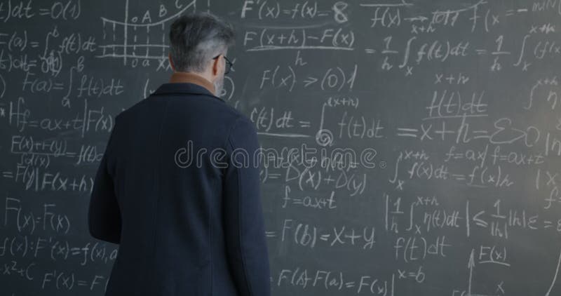 Back View of Man Professor Walking To Chalkboard Thinking and ...