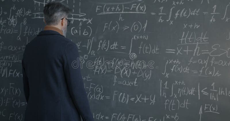 Back View of Man Professor Walking To Chalkboard Thinking and ...