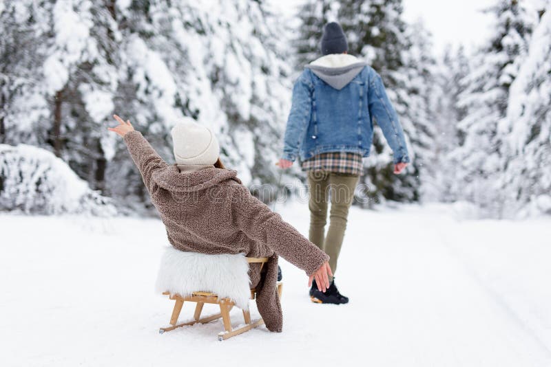 Back View of Man Pulling Sledge with Woman in Winter Forest Stock Image ...