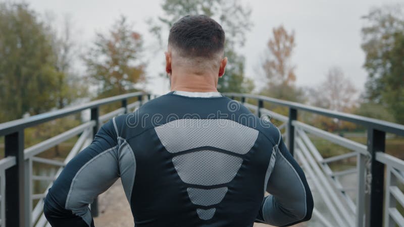 Back View of the Man Runner Jogging on Bridge. Athlete Doing Cardio ...