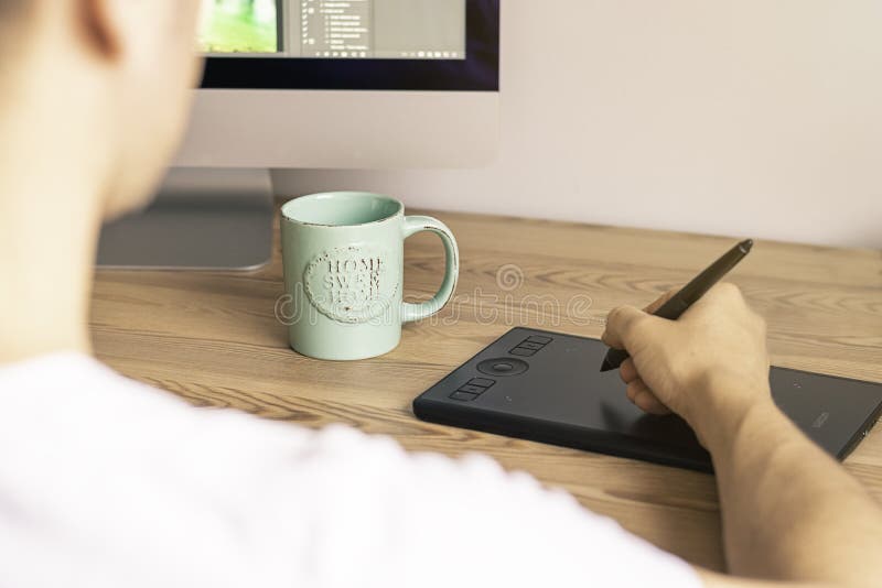 Back View a Man Sitting in Front of the Computer and Working with a ...