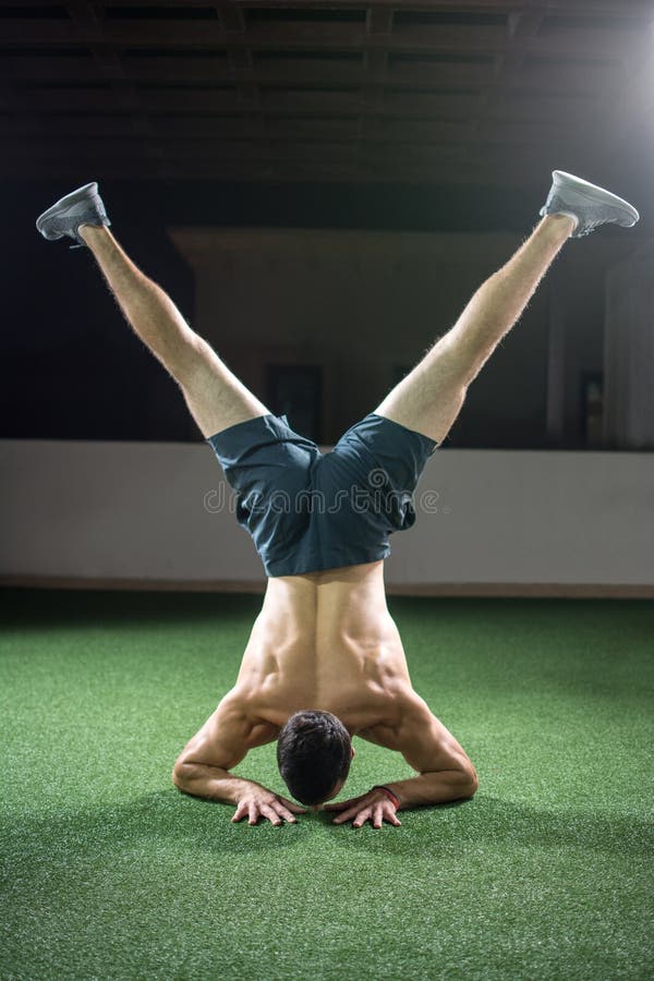 Back View of Man Standing on Arms with Raised Legs Stock Image - Image ...