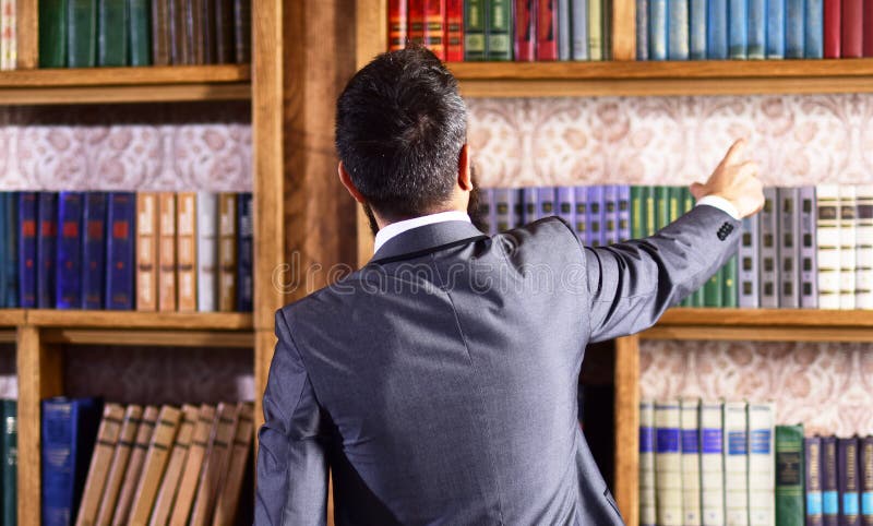 Back View of Man Standing and Searching Book in Library Stock Image ...