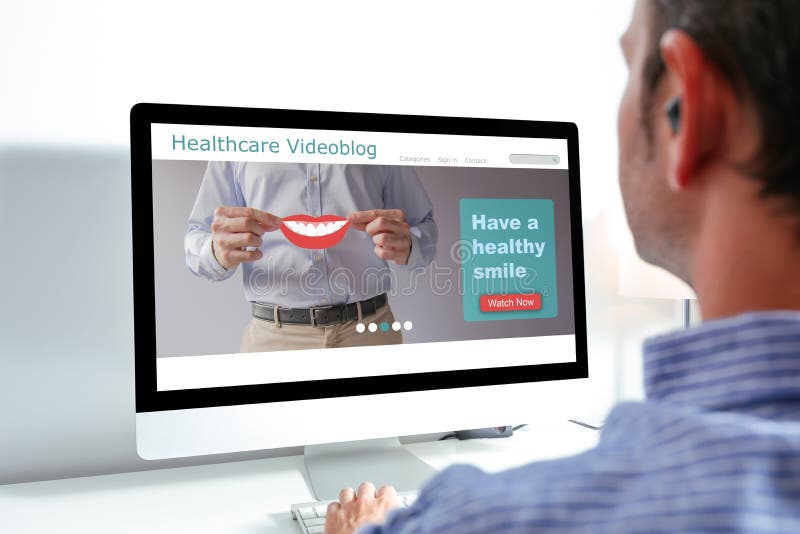 Back View of Man Using Computer with Health Videoblog on the Screen ...