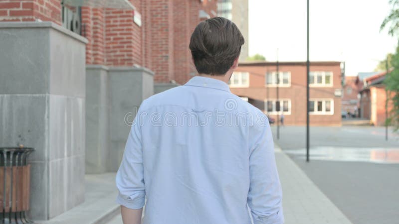 Back View of Man Walking in a Street Stock Video - Video of outdoor ...