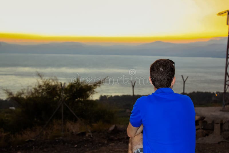Back View of Man Watching the Sunset at the Sea of Galilee Stock Image ...
