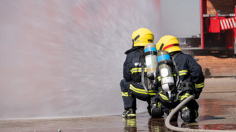 The Back View of Many Firefighters is Practicing Using Fire Stock Image ...