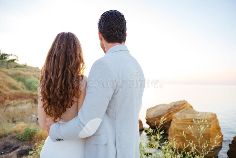 Back View of a Married Couple Hugging on the Beach Stock Photo - Image ...
