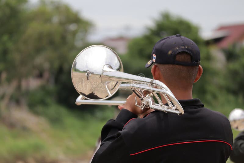 Back View of a Musician Holding a Trombone Instrument Outdoors ...