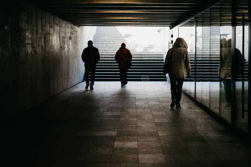 Back View of People Walking in Dark Underground Passway Stock Image ...