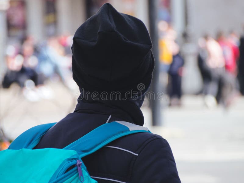 Back View of a Person with a Black Hat and a Blue Backpack Stock Image ...