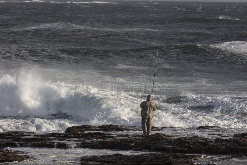 Back View of a Person Fishing in the Sea with Large Waves Stock Photo ...