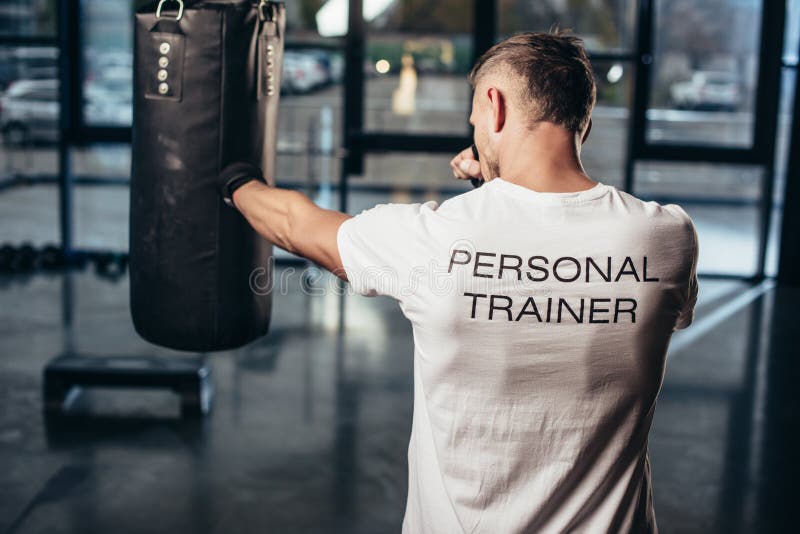 Back View of Personal Trainer Boxing with Punching Bag Stock Photo ...