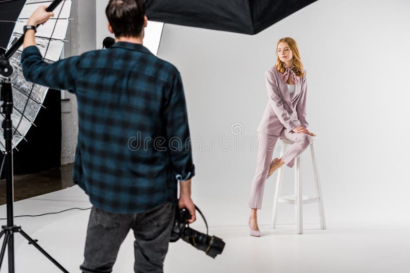 Back View of Photographer Holding Camera and Model Posing Stock Photo ...