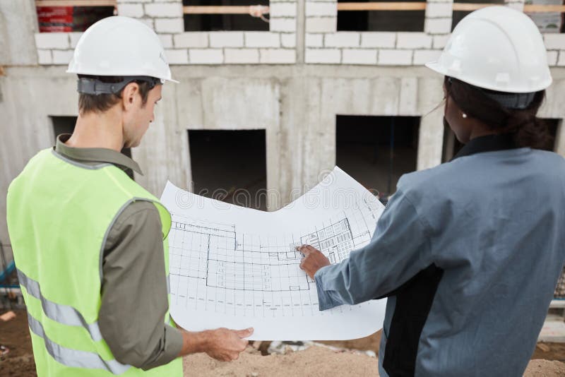 Two Workers Discussing Construction Plans Stock Image - Image of ...