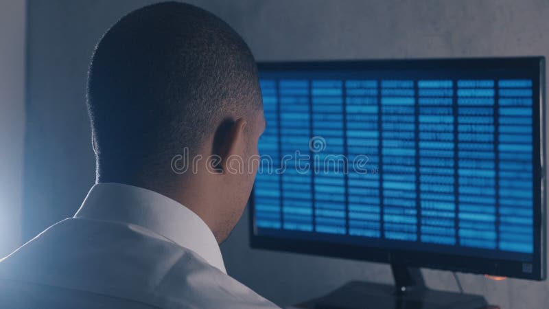 Back View of Programmer Professional Programming Code on Computer Monitor at Night Office Stock ...
