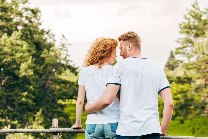 Back View of Redhead Couple Embracing and Smiling Each Other while ...