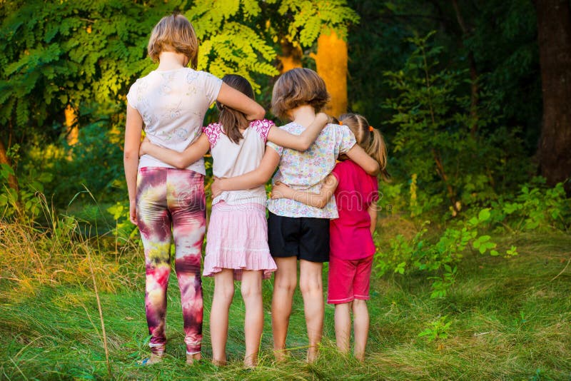 Back View of Sad Children Stand in Hug Together in Summer Stock Photo ...