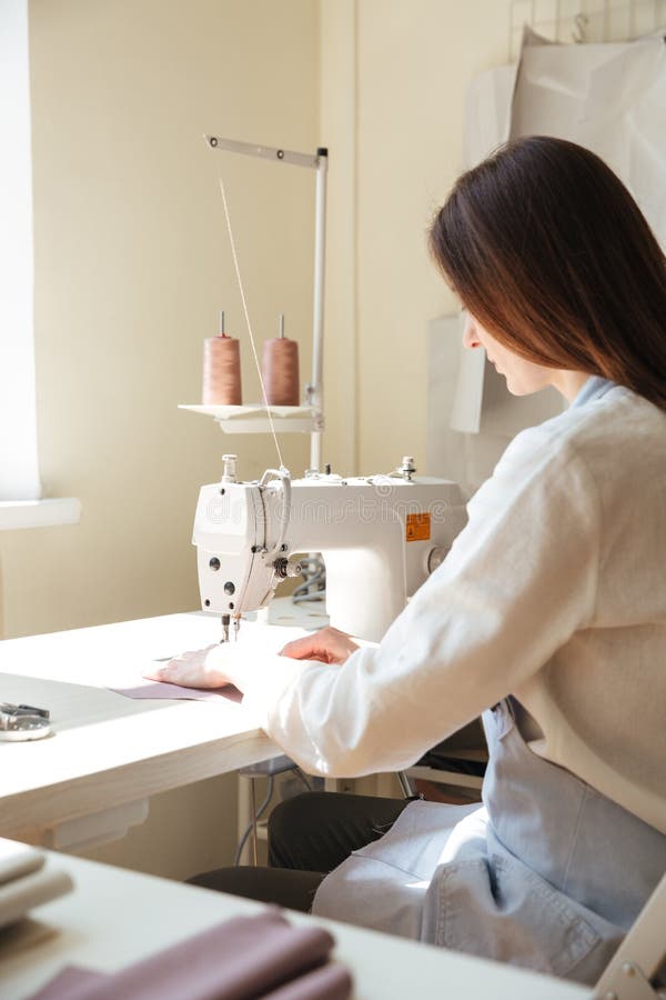 Back View of Seamstress Working with Sewing Machine Stock Image - Image ...
