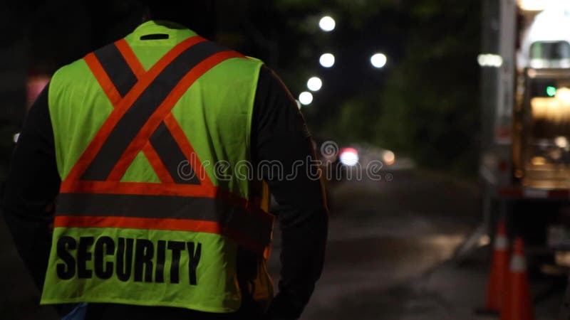 Back View of a Security Guard Standing in Front of an Accident at the ...
