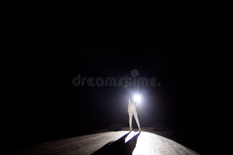 Back View of a Singer with Microphone Singing a Song on Stage in White ...