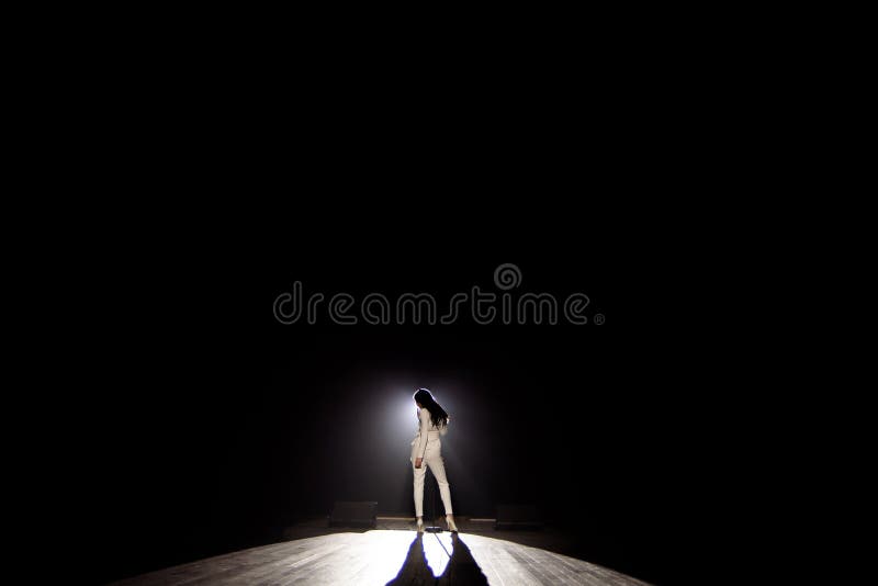 Back View of a Singer with Microphone Singing a Song on Stage in White ...
