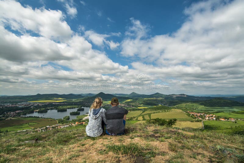 Back View of Sitting on Greenery Field with Dense Trees Stock Image ...