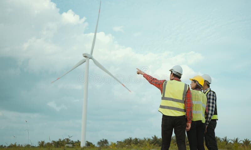 Back View of Three Engineers Discussing and Progress Check Wind Turbine ...