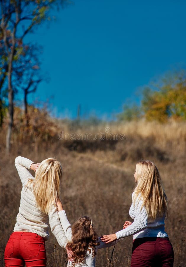 Three Sisters Holding Hands Stock Photos - Download 234 Royalty Free Photos