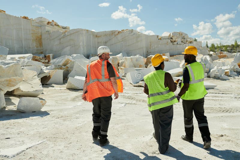 Back View of Three Workers of Marble Quarry Moving Down Territory of ...