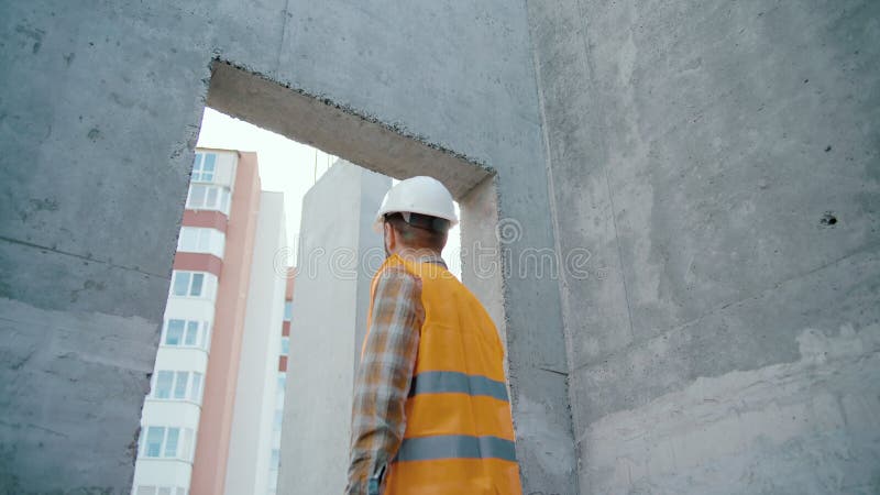 Back View of Tired Builder Looking Out of Window at Construction Site ...