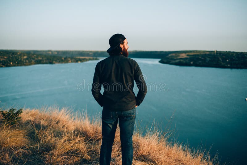 Back View of Traveler Man Looking at Beautiful Blue River during ...