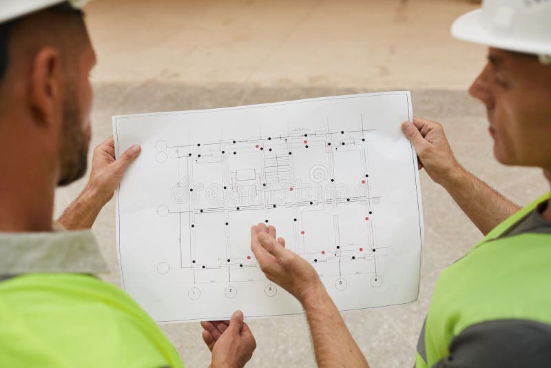 Construction Workers Discussing Plans Stock Photo - Image of blueprint ...