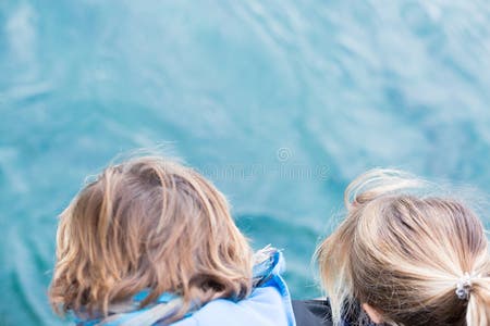 Back View of Two Children Looking Down at Water Stock Image - Image of ...