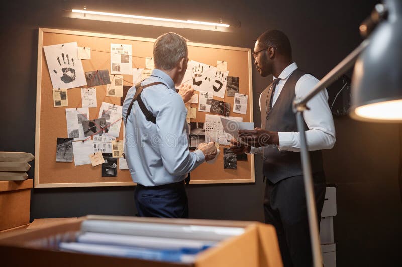 African American Detective Pointing at Evidence Board Investigating ...