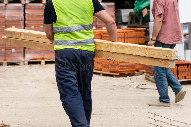 Back View of Unknown Man Construction Worker Holding and Carry Lumber ...