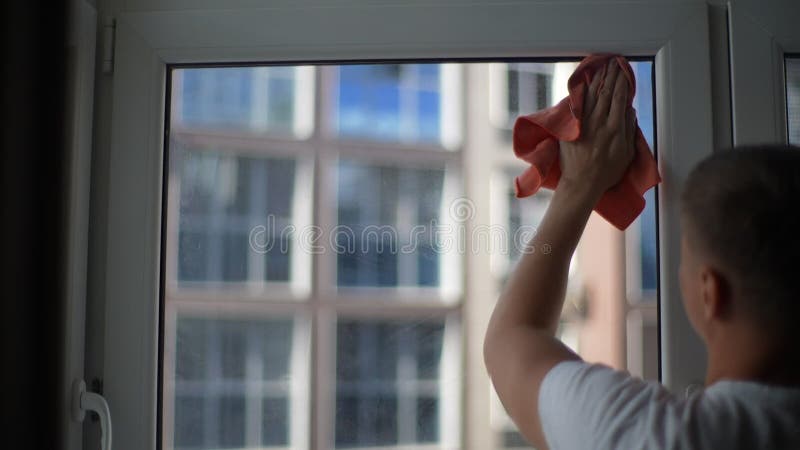 Back View of Unrecognizable Man Wiping Window in Apartment Room with ...