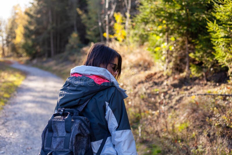 Back View of a Woman with Backpack Hiking in the Autumn Forest Stock ...