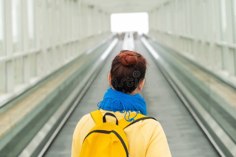 Back View of Woman with Backpack Moving on Escalator. Stock Photo ...