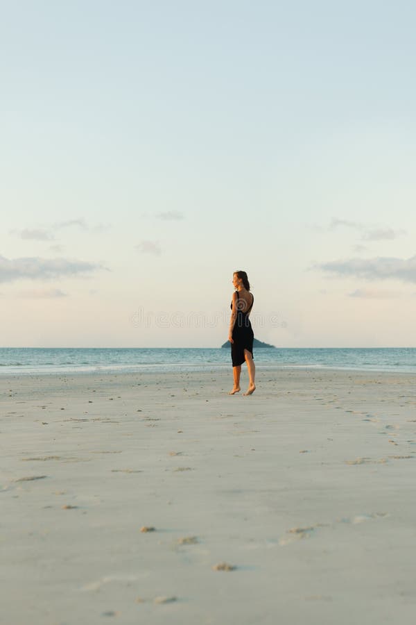 Back View of Woman Walking on Sandy Beach in Dress Stock Photo - Image ...