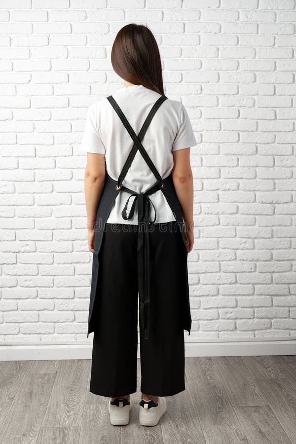 Back View Woman Wearing Apron in Front of a White Brick Wall Stock ...