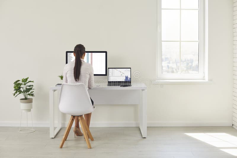 Back View of Woman Sitting at Office Desk and Working on Desktop ...