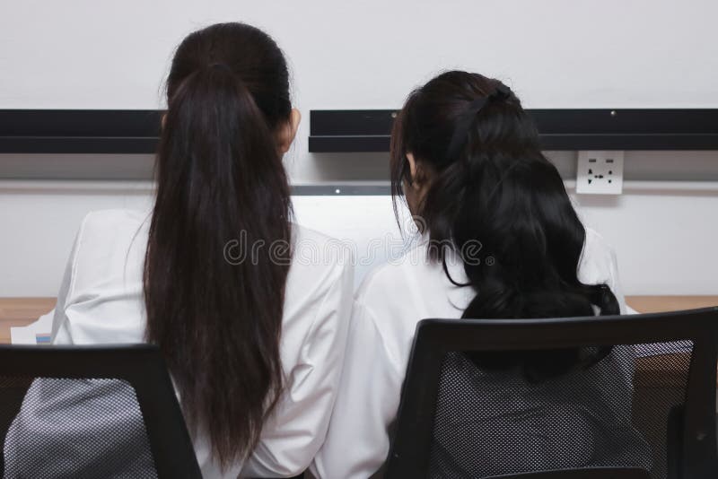 Back View of Young Asian Women Working Together on Workplace Stock ...