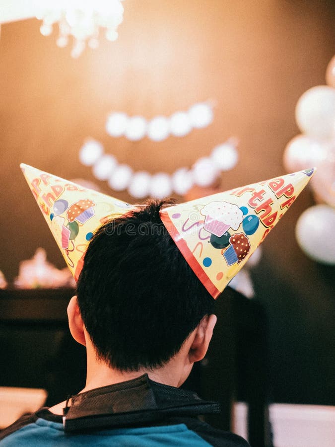 Back View of a Young Boy with Party Hats Stock Photo - Image of ...