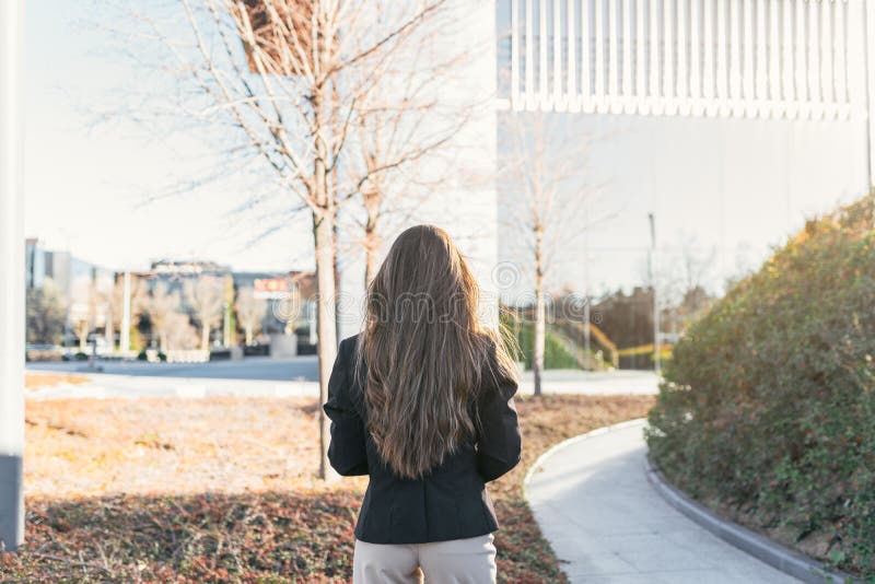 Back View of a Young Business Woman in a Financial Building Area Stock ...