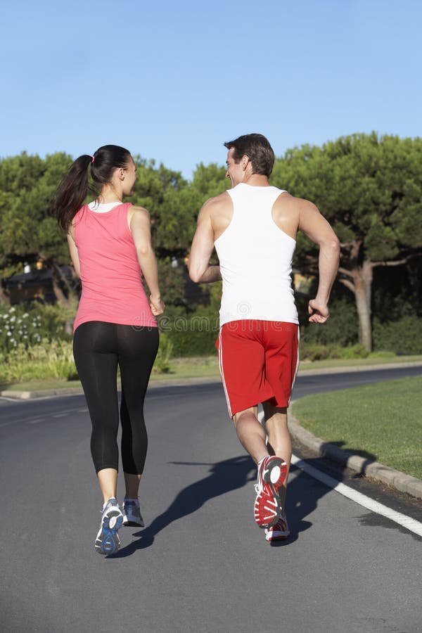 Back View of Young Couple Running on Road Stock Photo - Image of ...