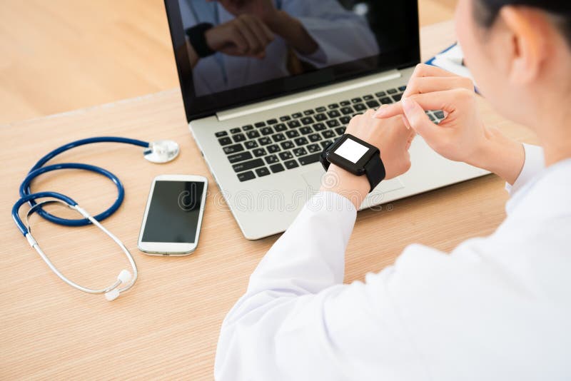 Back View of Young Female Doctor Using Smartwatch Stock Photo - Image ...